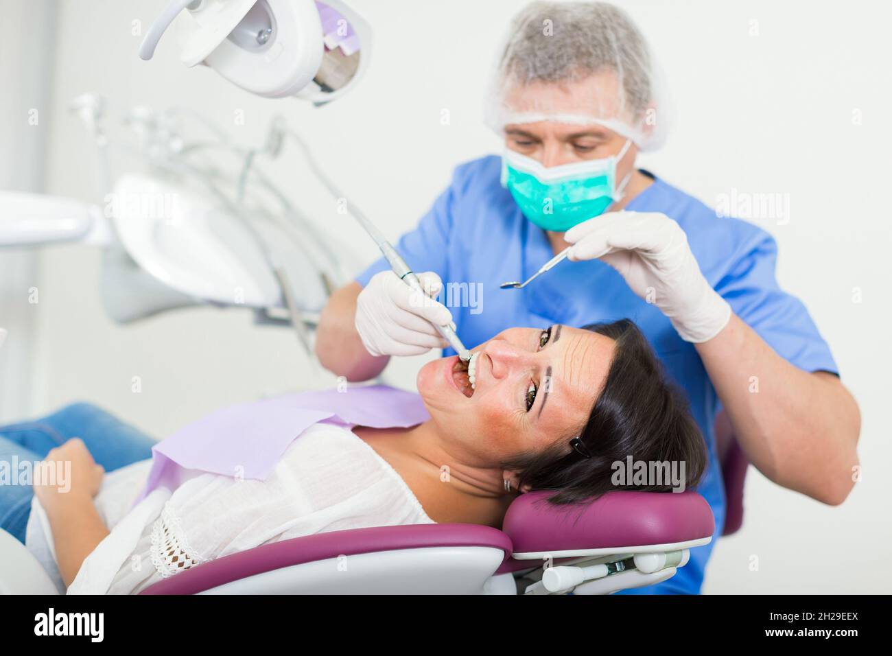 adult dentist checking teeth Stock Photo - Alamy