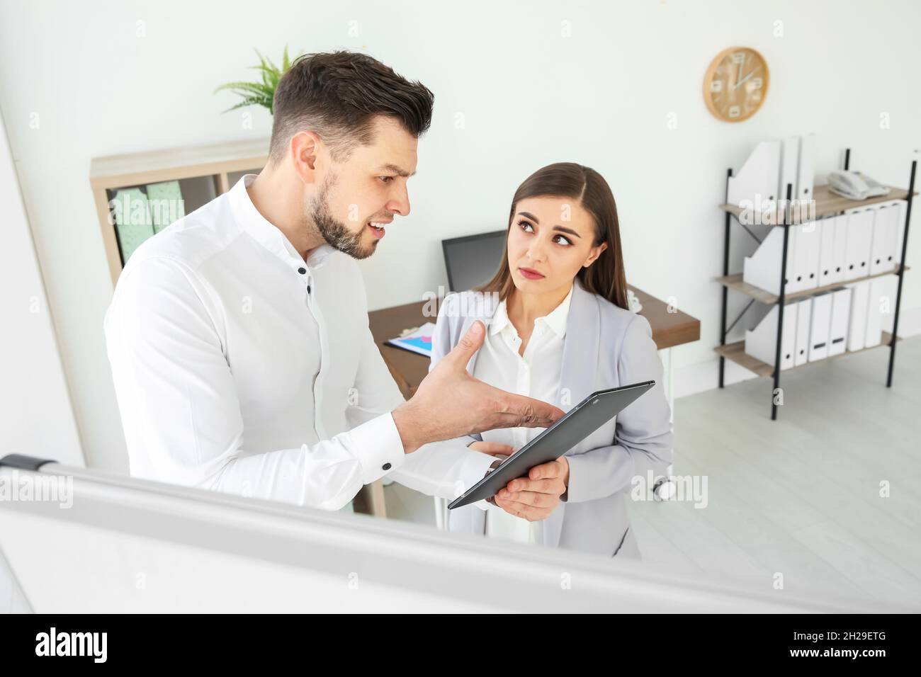 Office employees having argument at workplace Stock Photo - Alamy