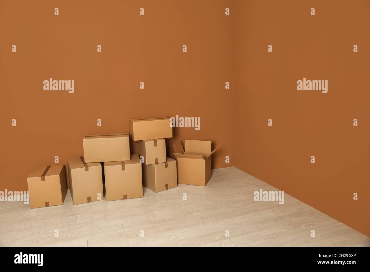 Cardboard boxes on floor indoors Stock Photo - Alamy