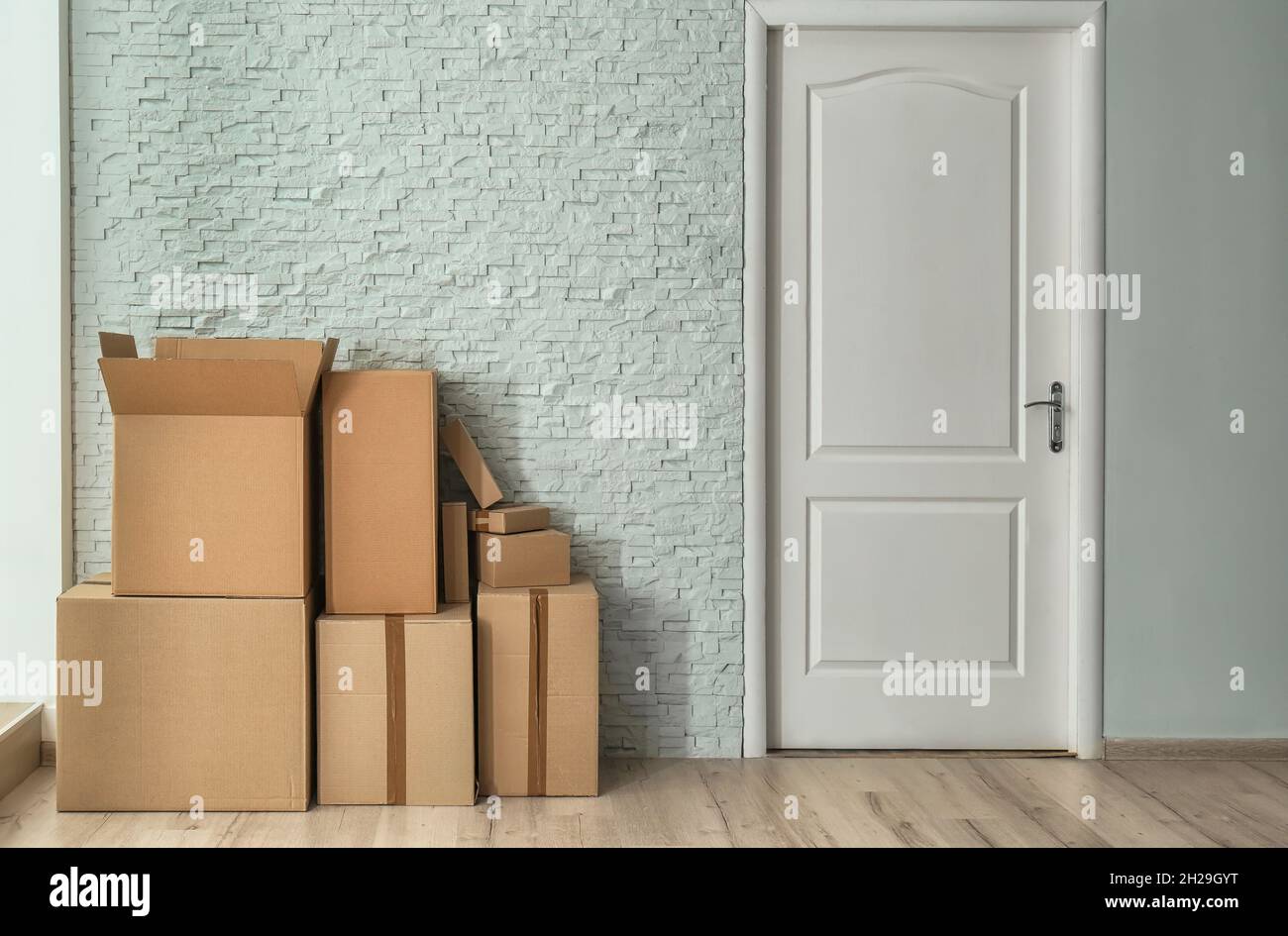 Cardboard boxes on floor indoors Stock Photo - Alamy