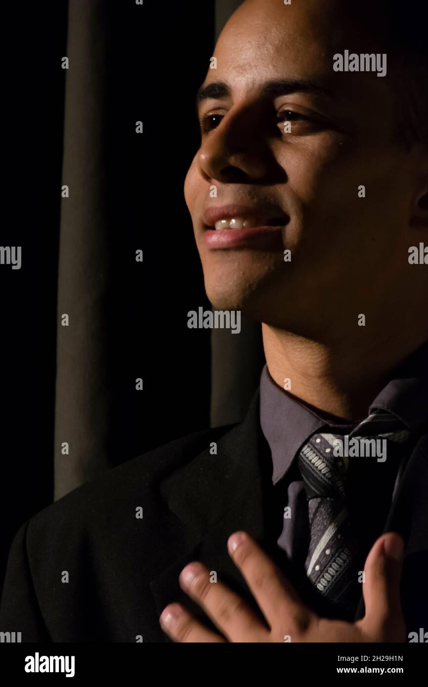 Standing actor representing a character in a theater. Black background ...