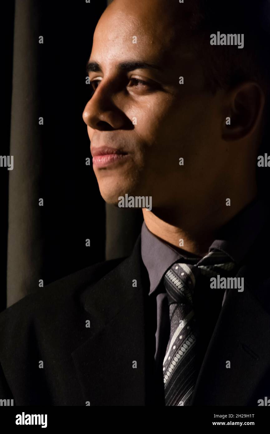 Standing actor representing a character in a theater. Black background ...