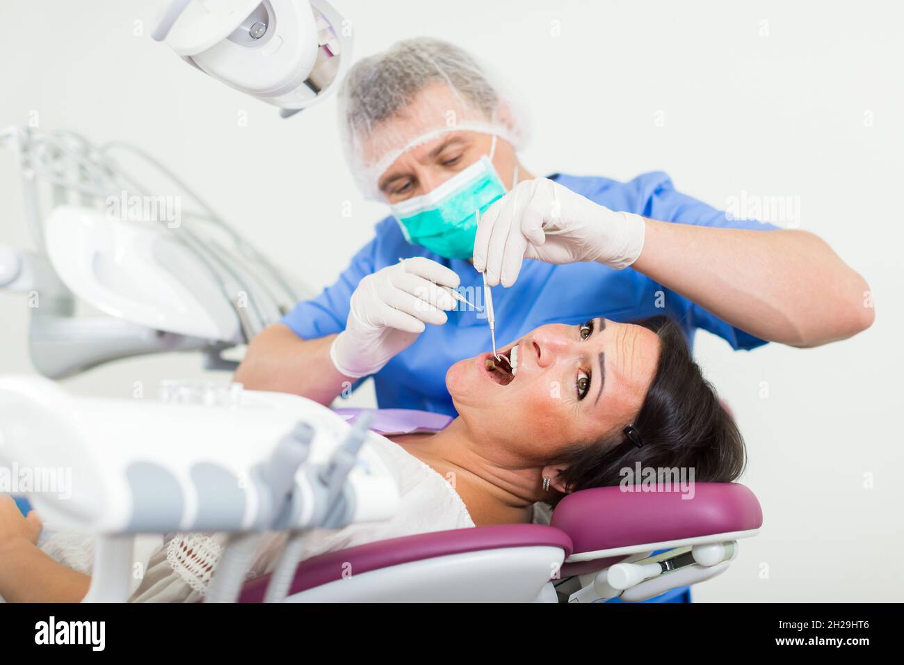 adult dentist checking teeth Stock Photo - Alamy