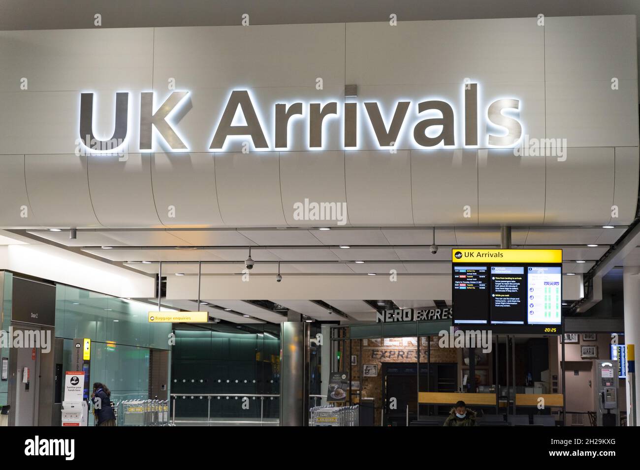 Air passengers arrive at arrival hall at Heathrow International airport ...