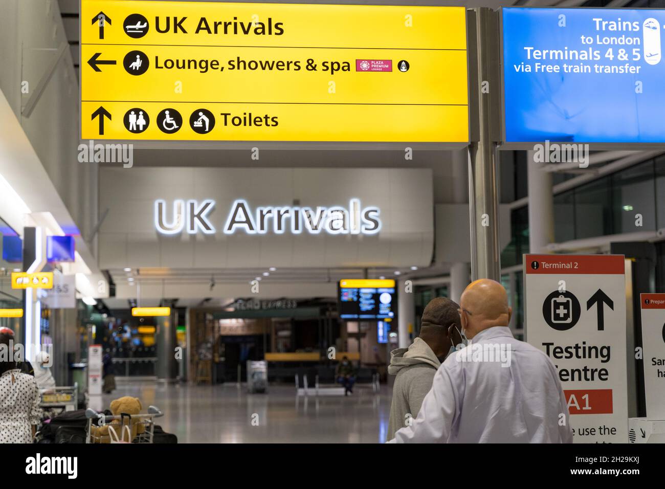 Air passengers arrive at arrival hall at Heathrow International airport ...
