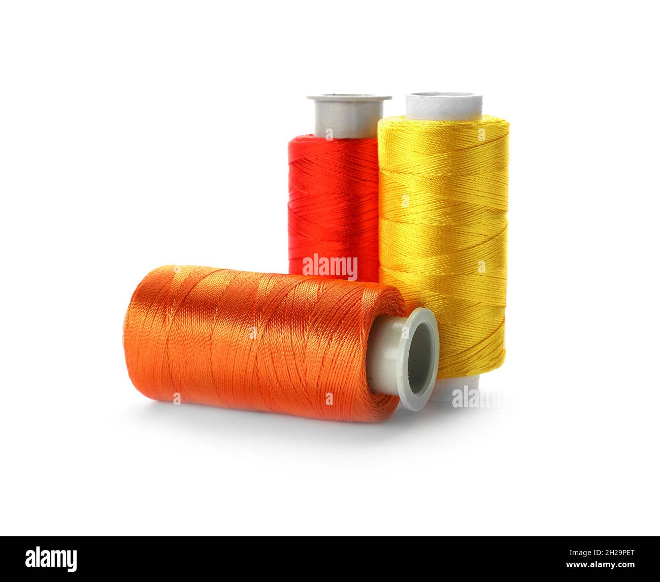 Color sewing threads on white background Stock Photo - Alamy
