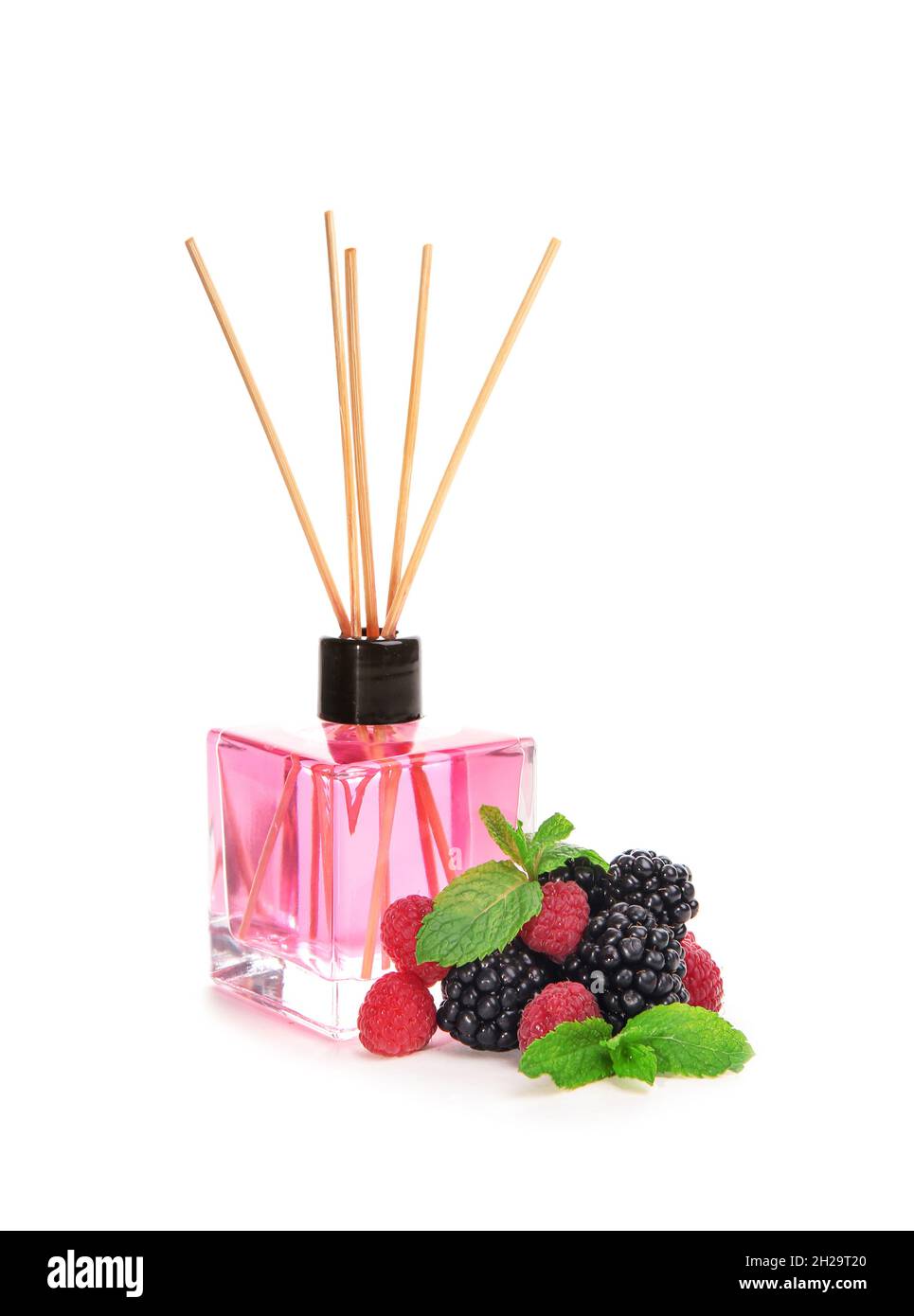 Aromatic reed air freshener and berries on white background Stock Photo ...