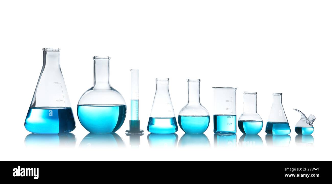 Laboratory glassware for chemical analysis with blue liquid on table ...
