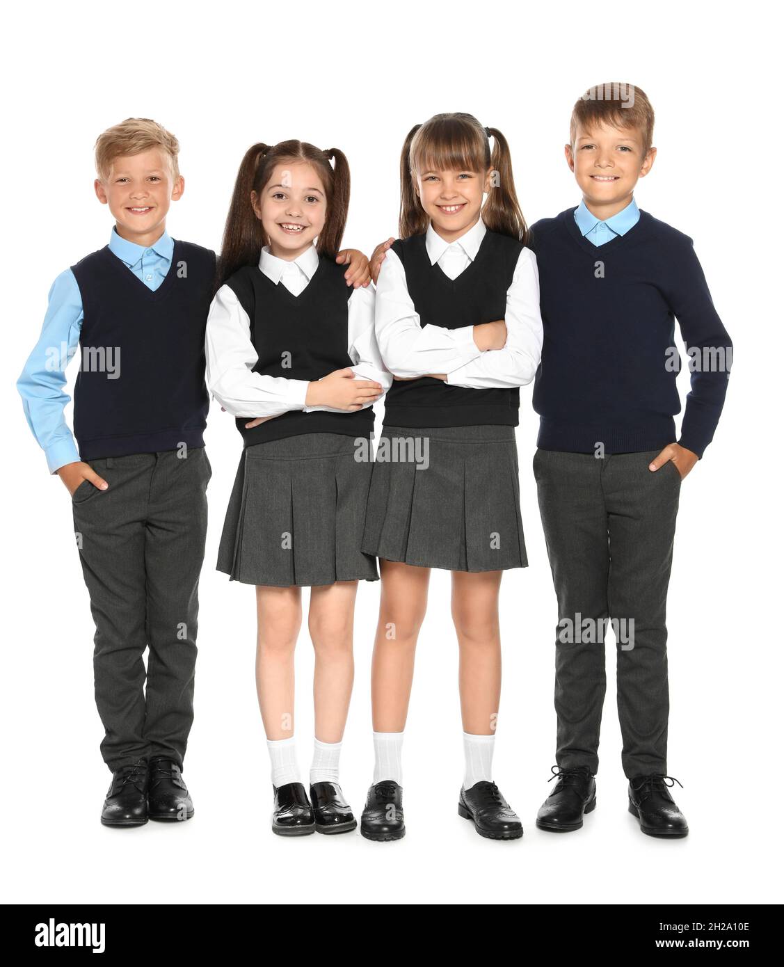 Little children in stylish school uniform on white background Stock ...