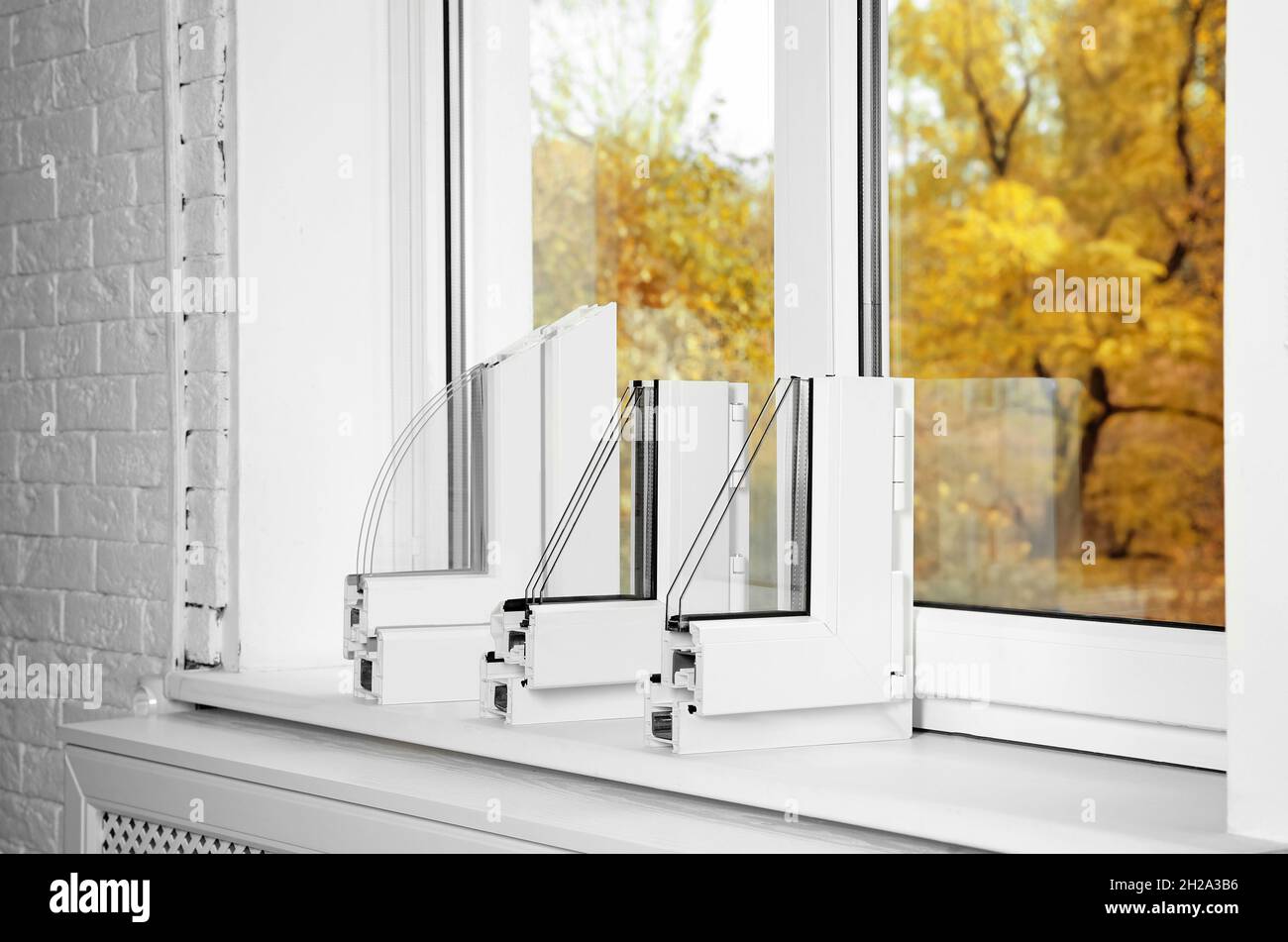 Samples of modern window profiles on sill indoors. Installation service ...