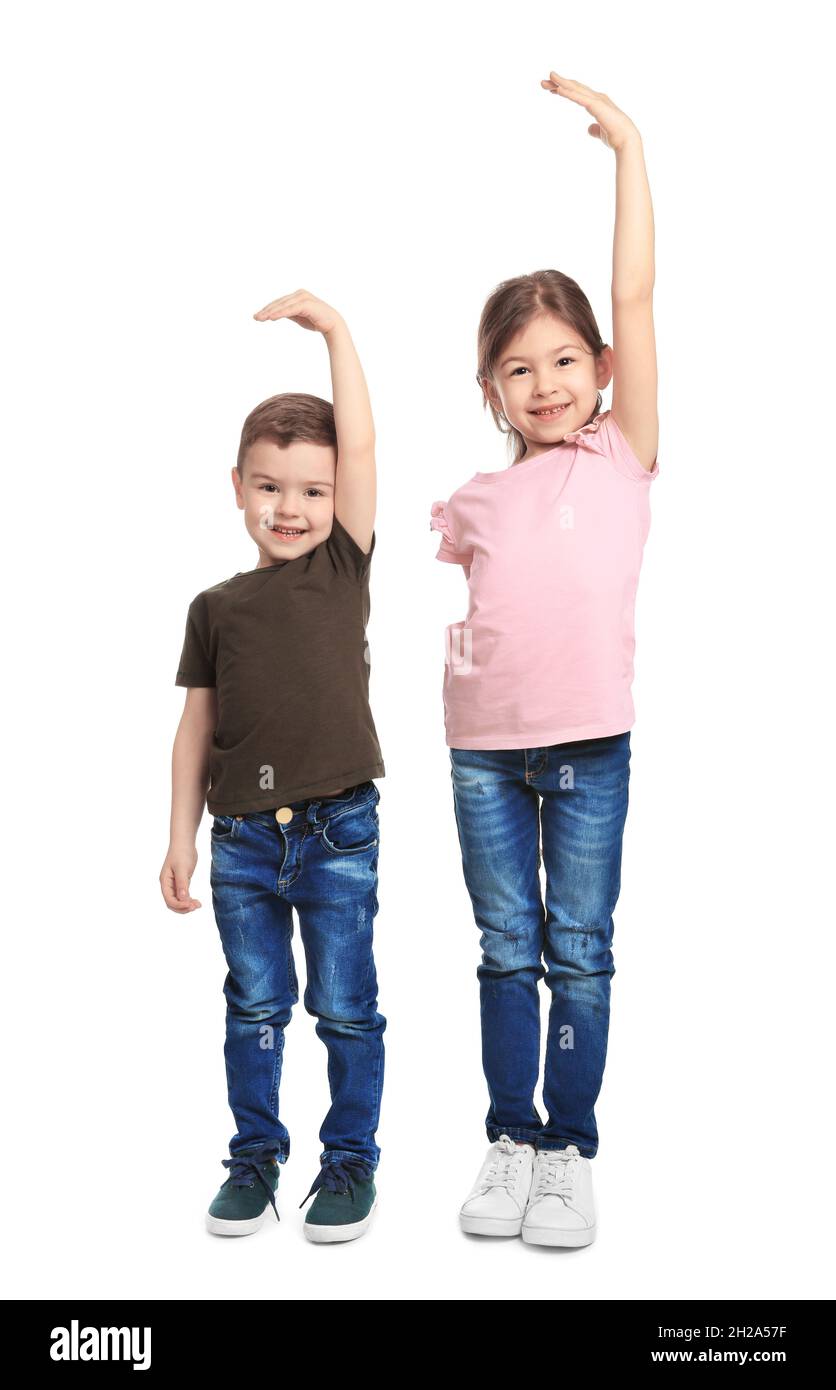 Little children measuring their height on white background Stock Photo ...