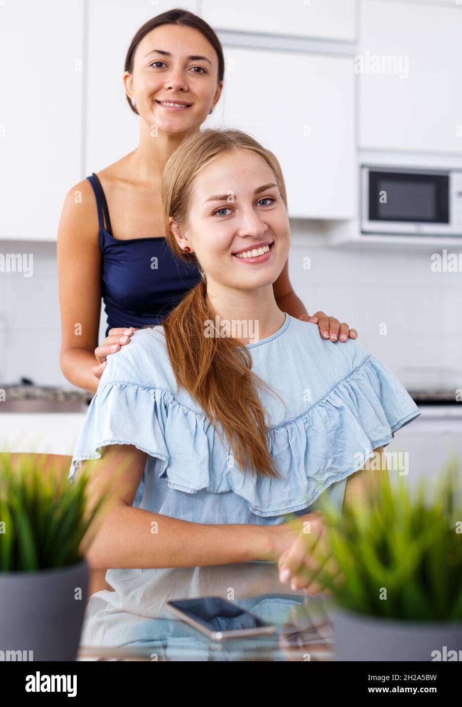 Two smiling girls friends in perfect mood Stock Photo - Alamy