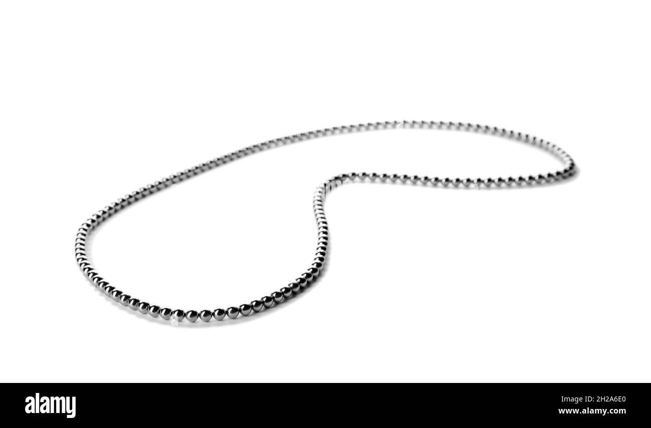 Chain of small magnetic balls on white background Stock Photo - Alamy