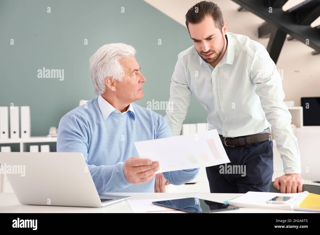 Office employees having argument at workplace Stock Photo - Alamy