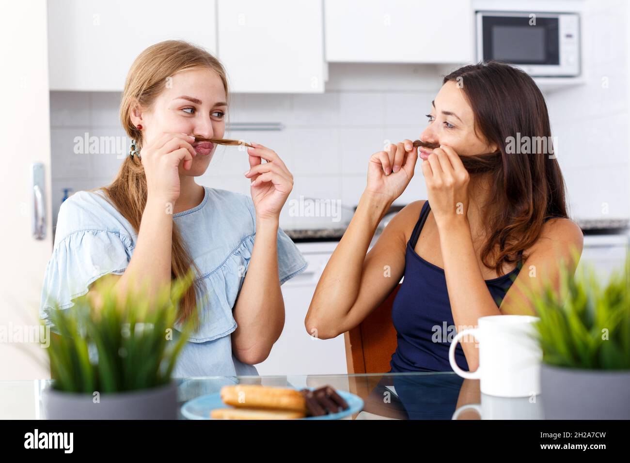 Portrait of two young friendly women Stock Photo - Alamy