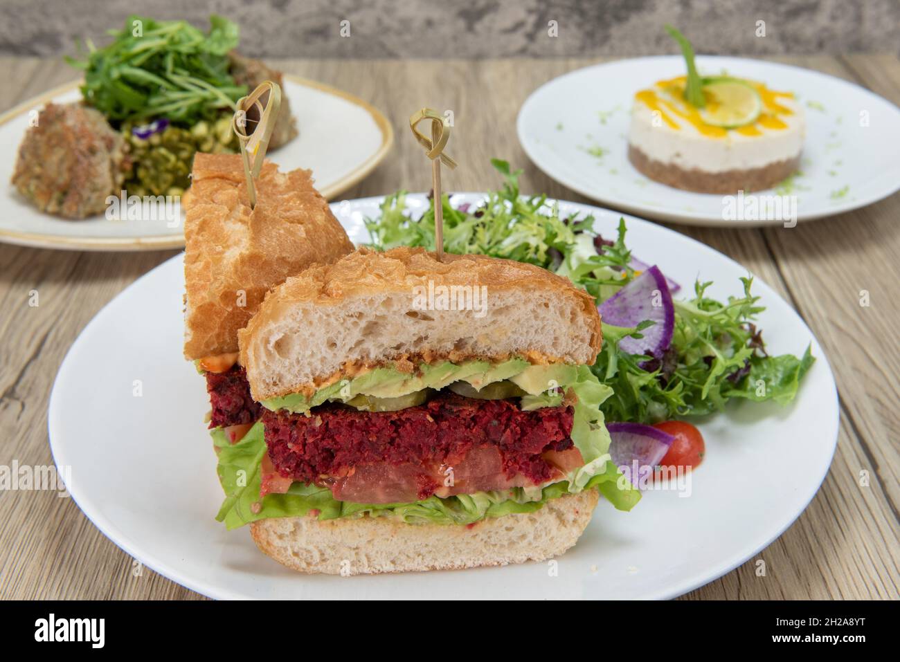 Three courses of food on the table beginning with the veggie burger ...