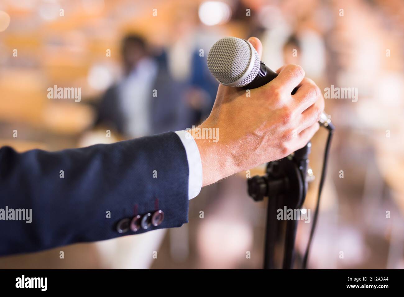 Closeup of male hand in formal suit holding microphone Stock Photo - Alamy