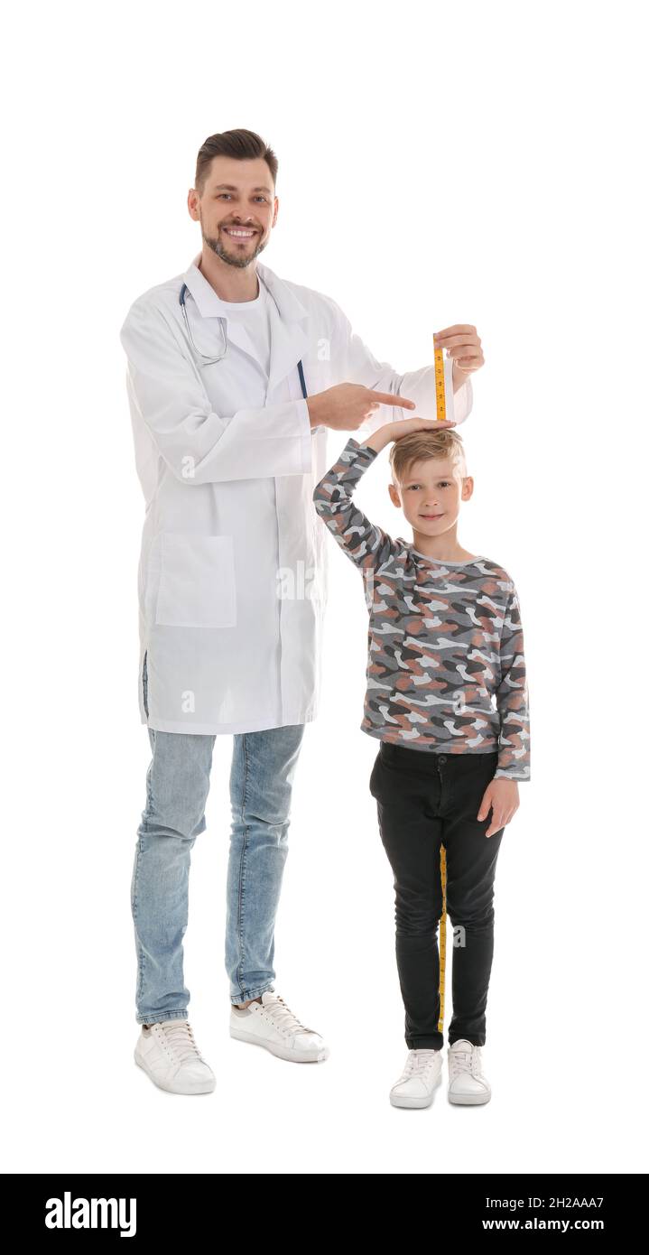 Doctor measuring little boy's height on white background Stock Photo ...