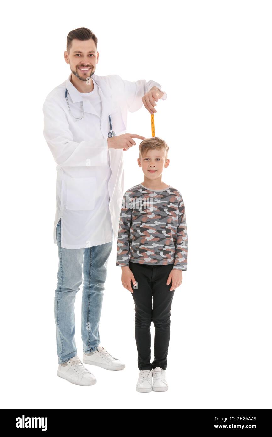 Doctor measuring little boy's height on white background Stock Photo ...
