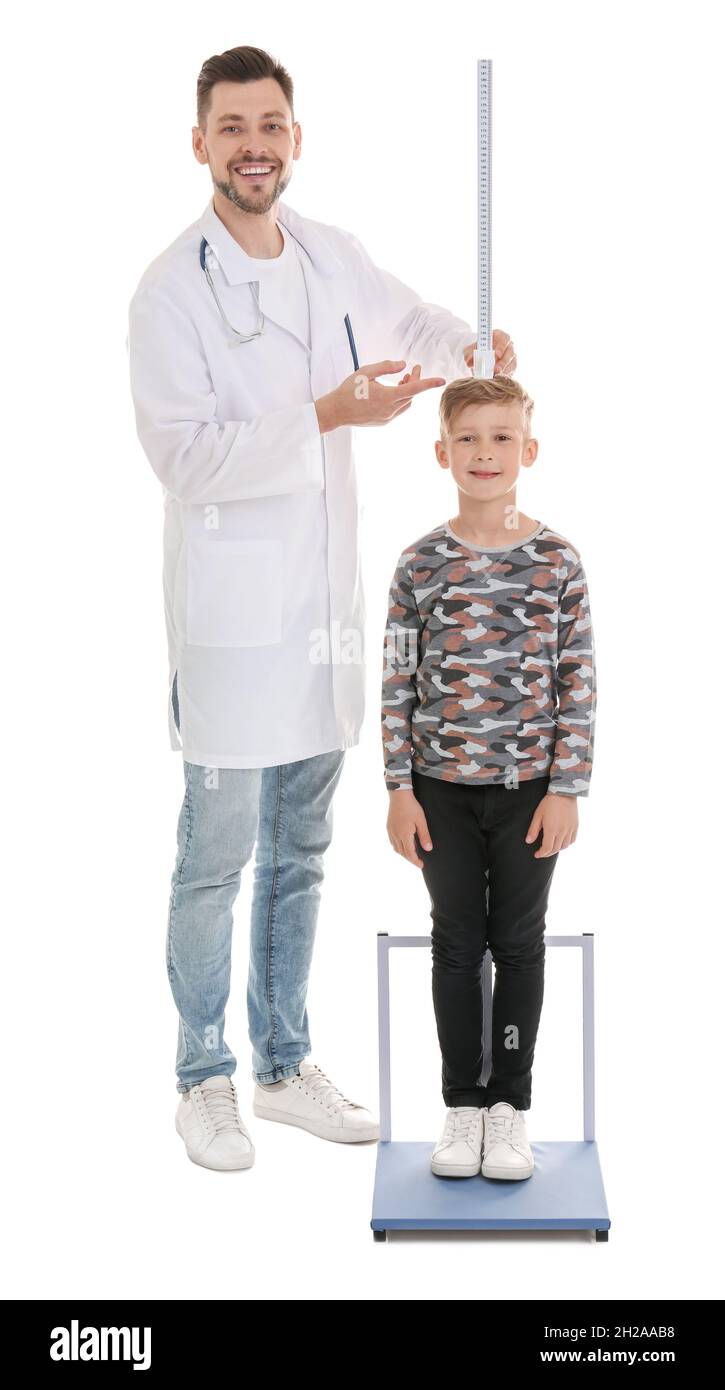 Doctor measuring little boy's height on white background Stock Photo ...