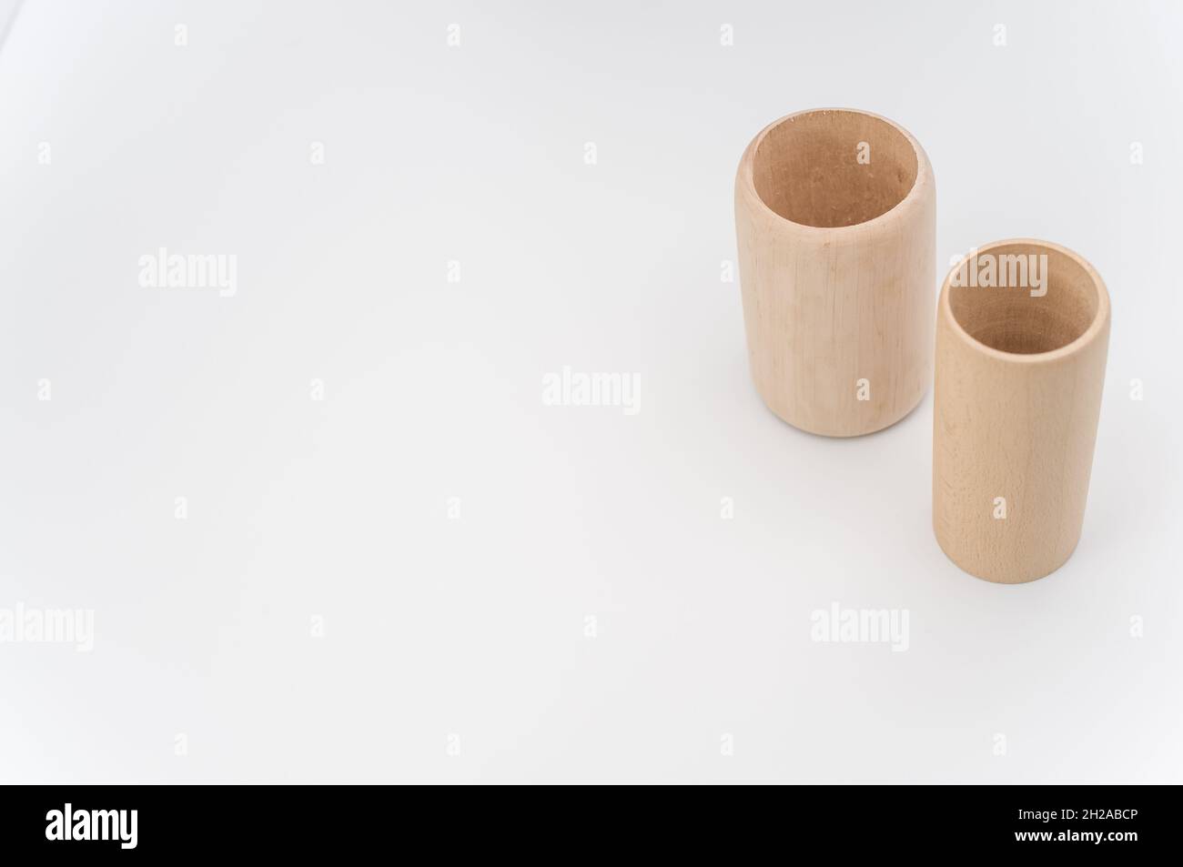 two wooden empty pen holder on a white background Stock Photo - Alamy