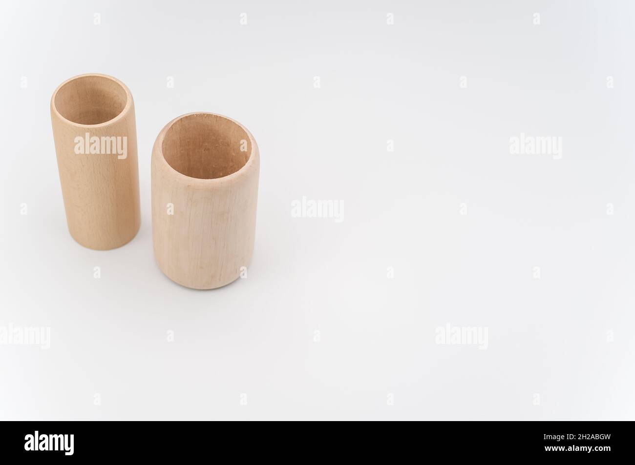 two wooden empty pen holder on a white background Stock Photo - Alamy