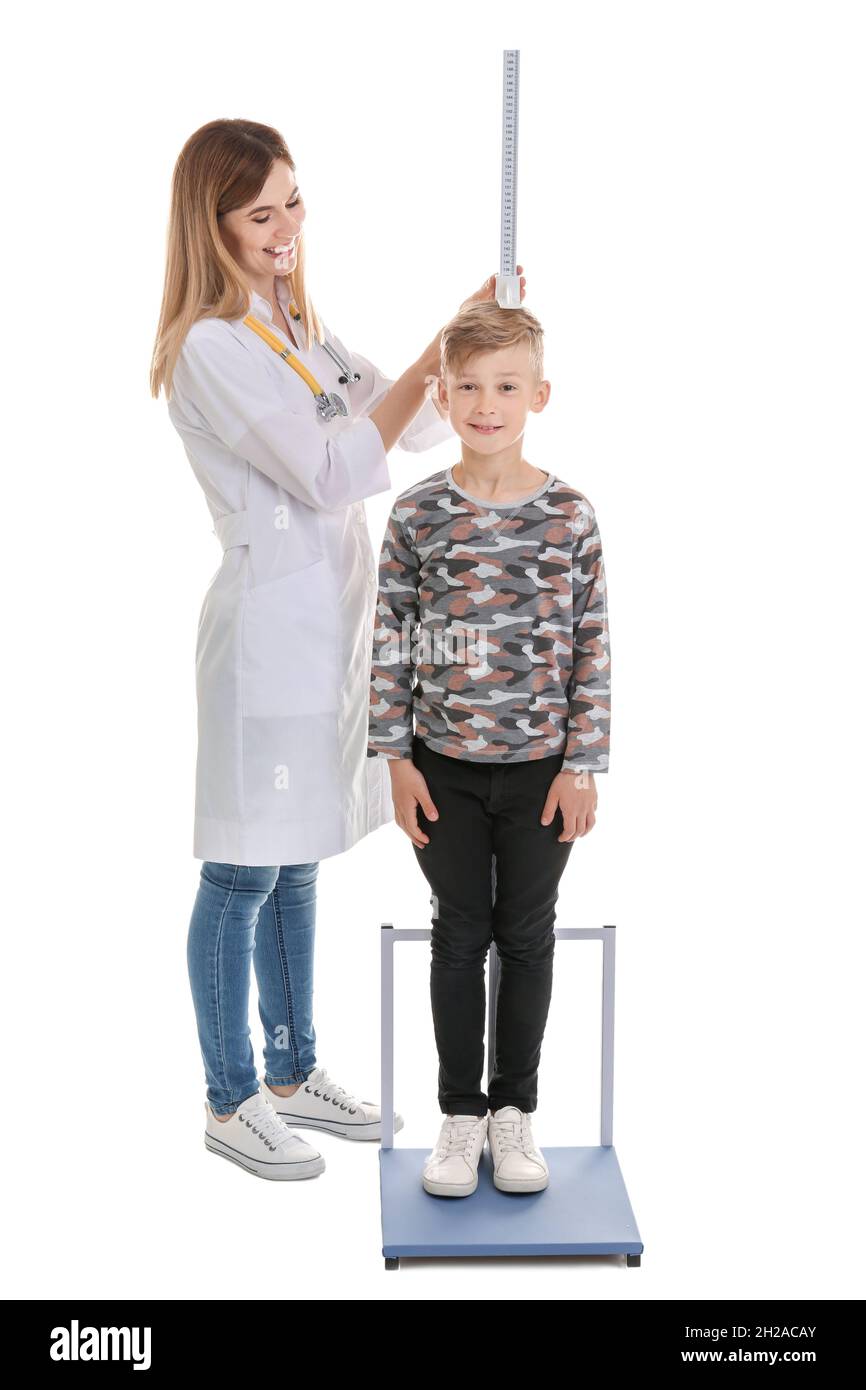 Doctor measuring little boy's height on white background Stock Photo ...