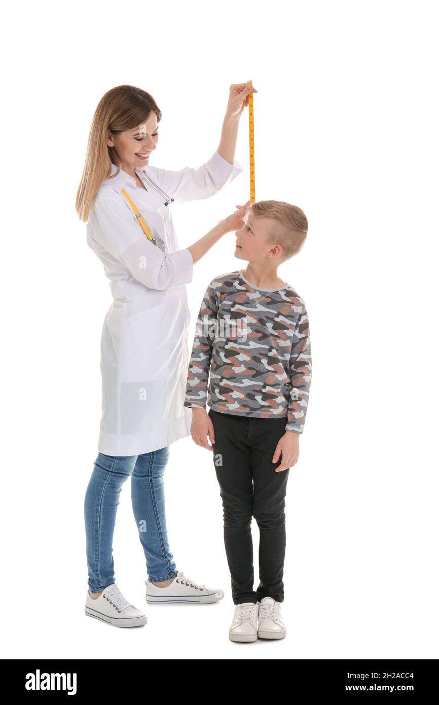 Doctor measuring little boy's height on white background Stock Photo ...