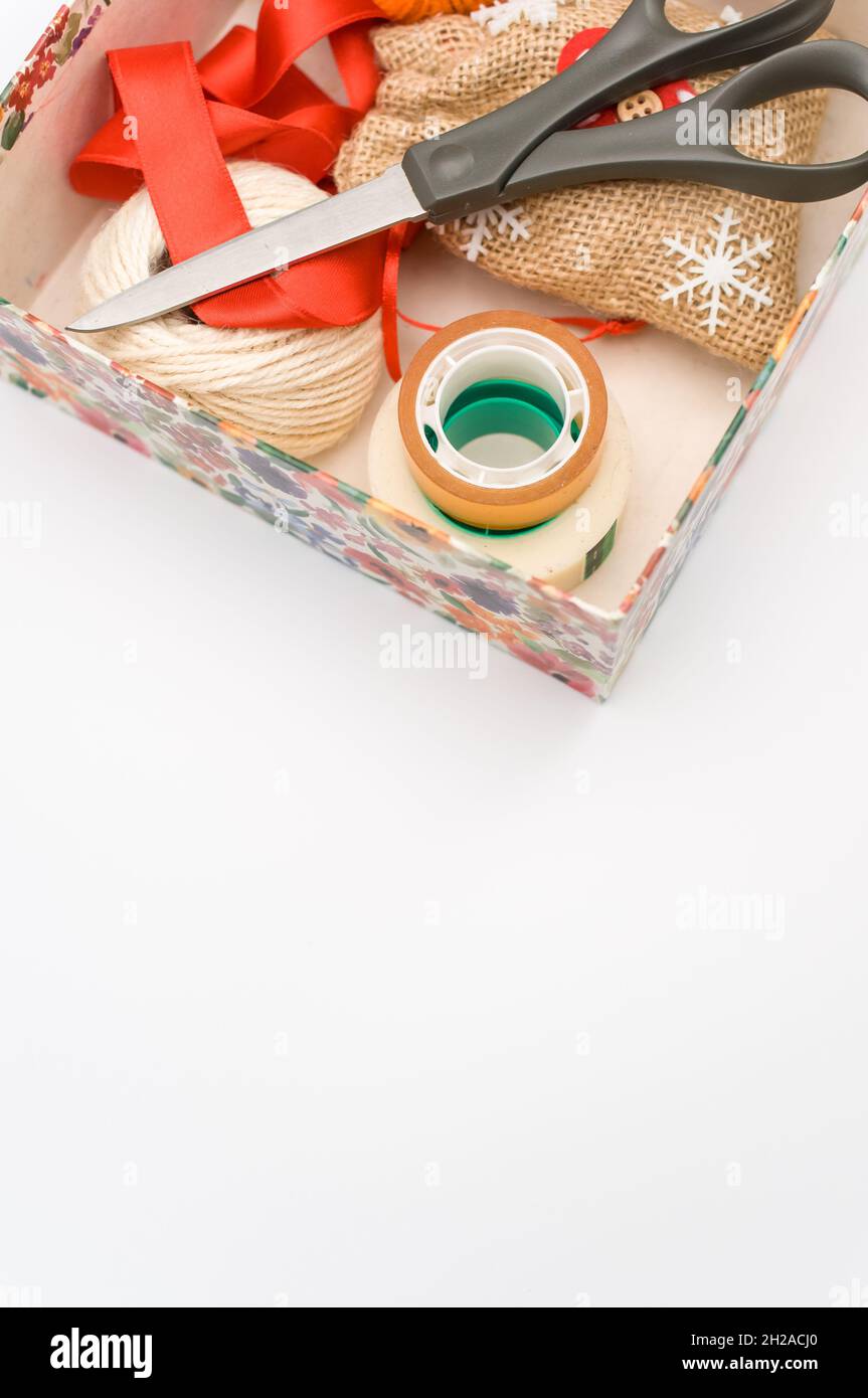 paperboard box with floral decorations and stationery on a white ...