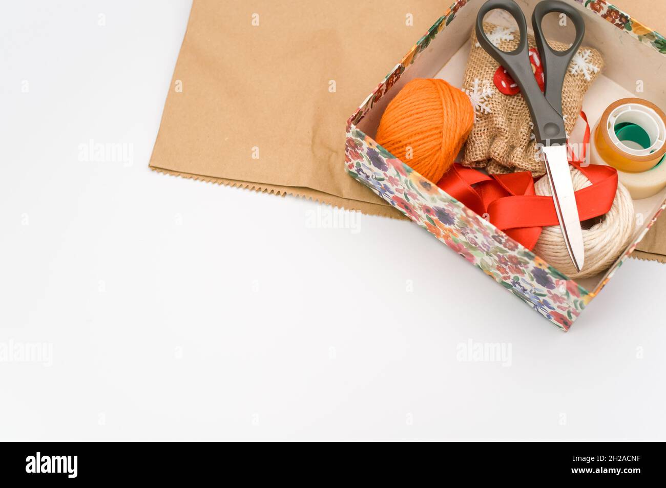 paperboard box with floral decorations and stationery on a white ...