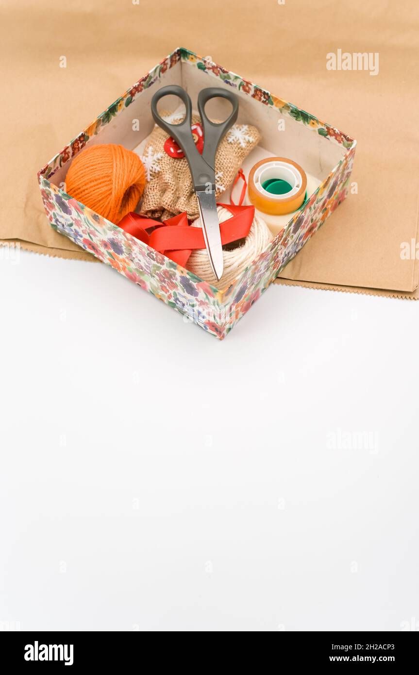 paperboard box with floral decorations and stationery on a white ...