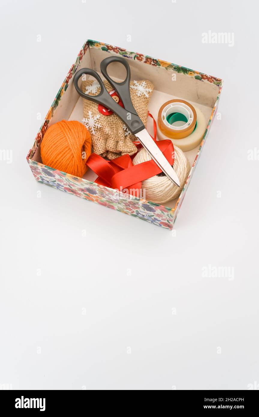 paperboard box with floral decorations and stationery on a white ...