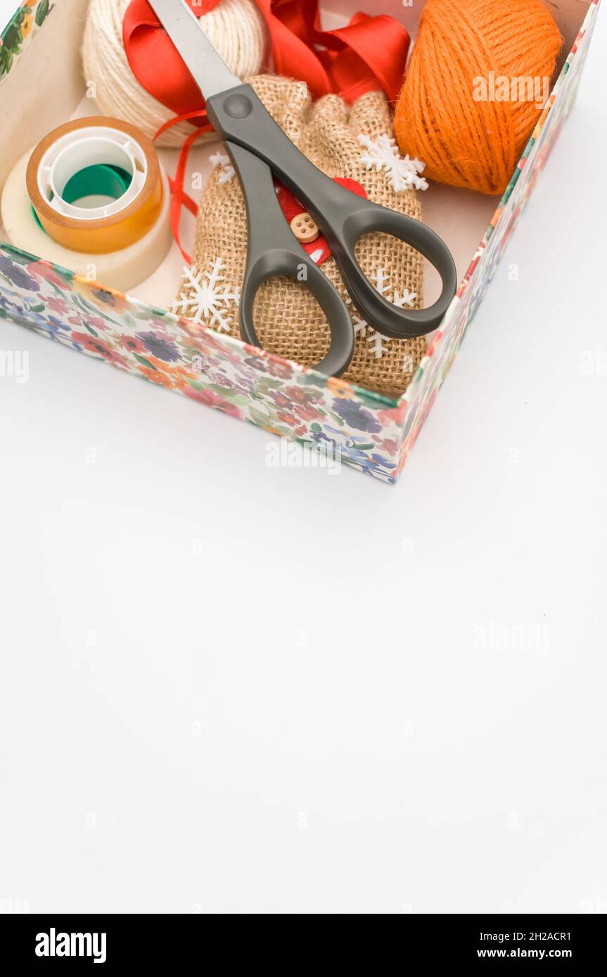 paperboard box with floral decorations and stationery on a white ...