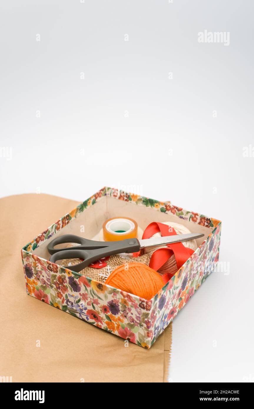 paperboard box with floral decorations and stationery on a white ...