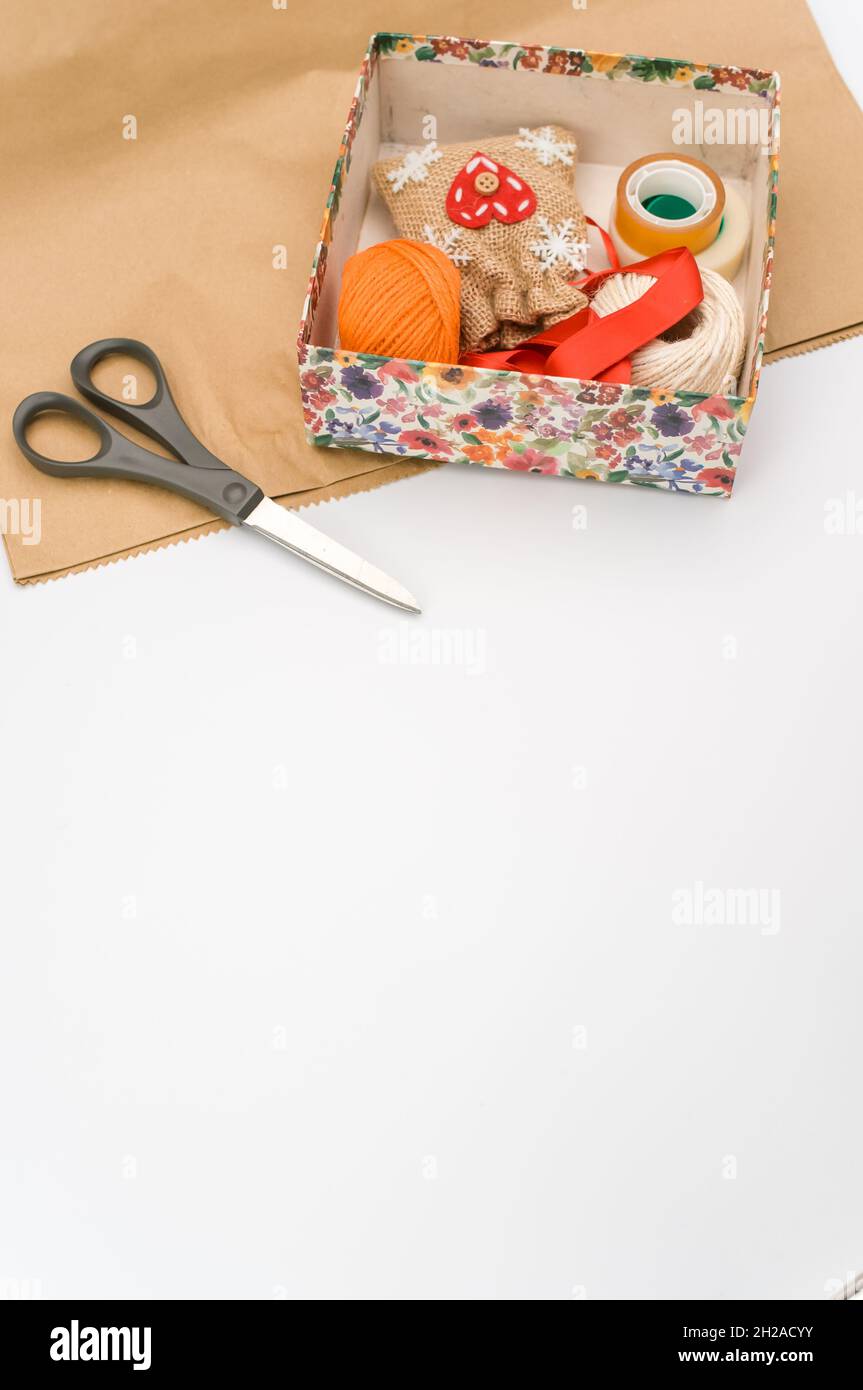 paperboard box with floral decorations and stationery on a white ...