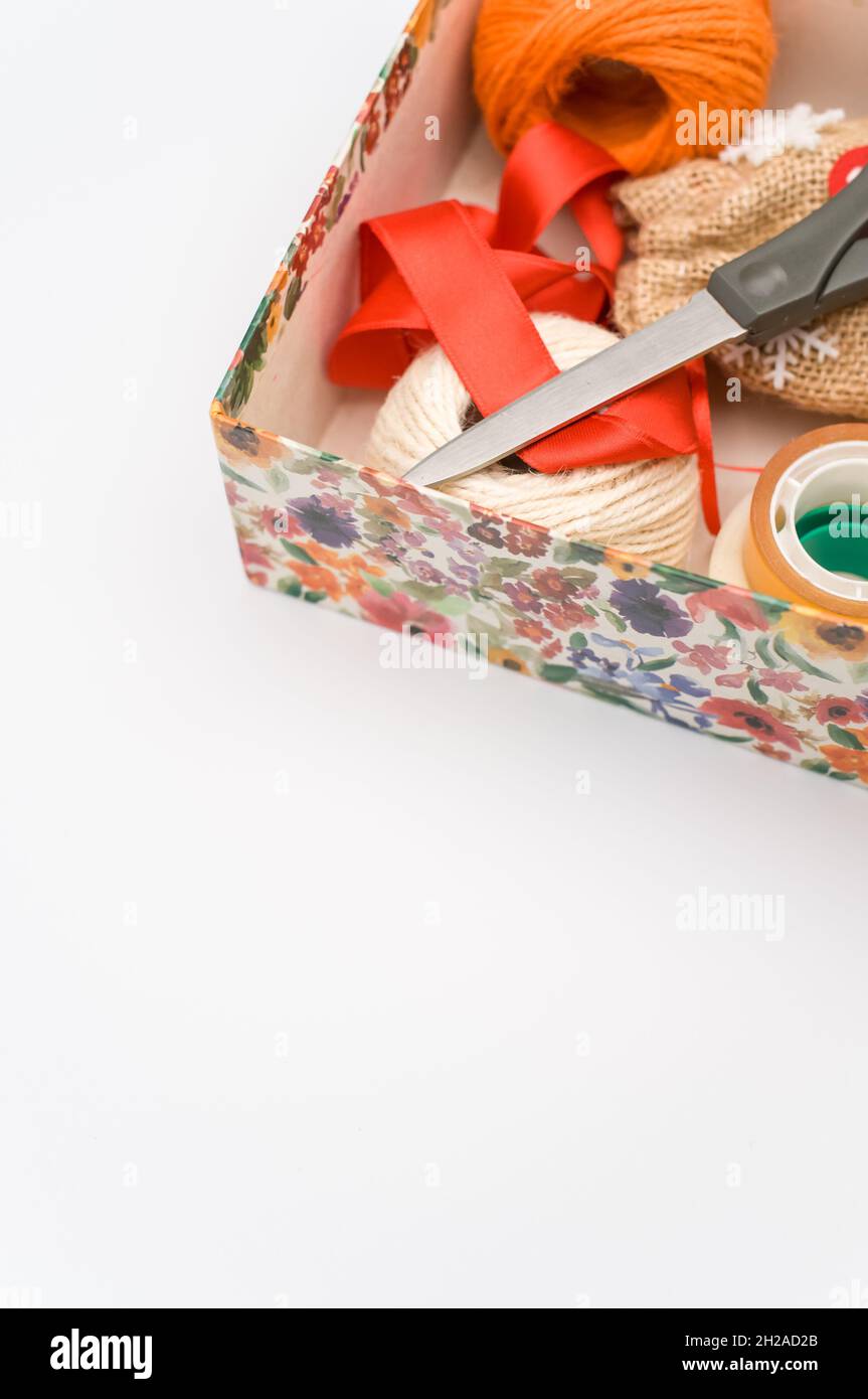 paperboard box with floral decorations and stationery on a white ...