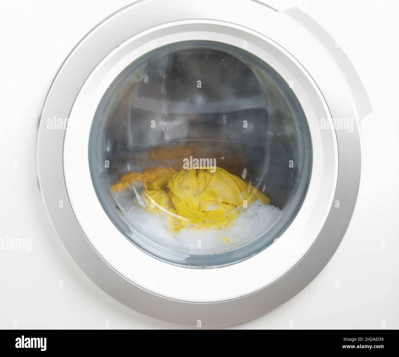 Washing machine with clothes, closeup. Laundry day Stock Photo - Alamy