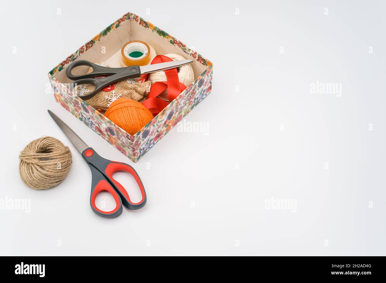 paperboard box with floral decorations and stationery on a white ...