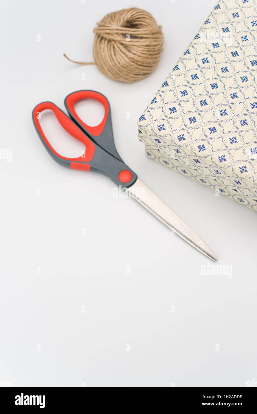 decorated paperboard box with scissors and decorative yarn on a white ...
