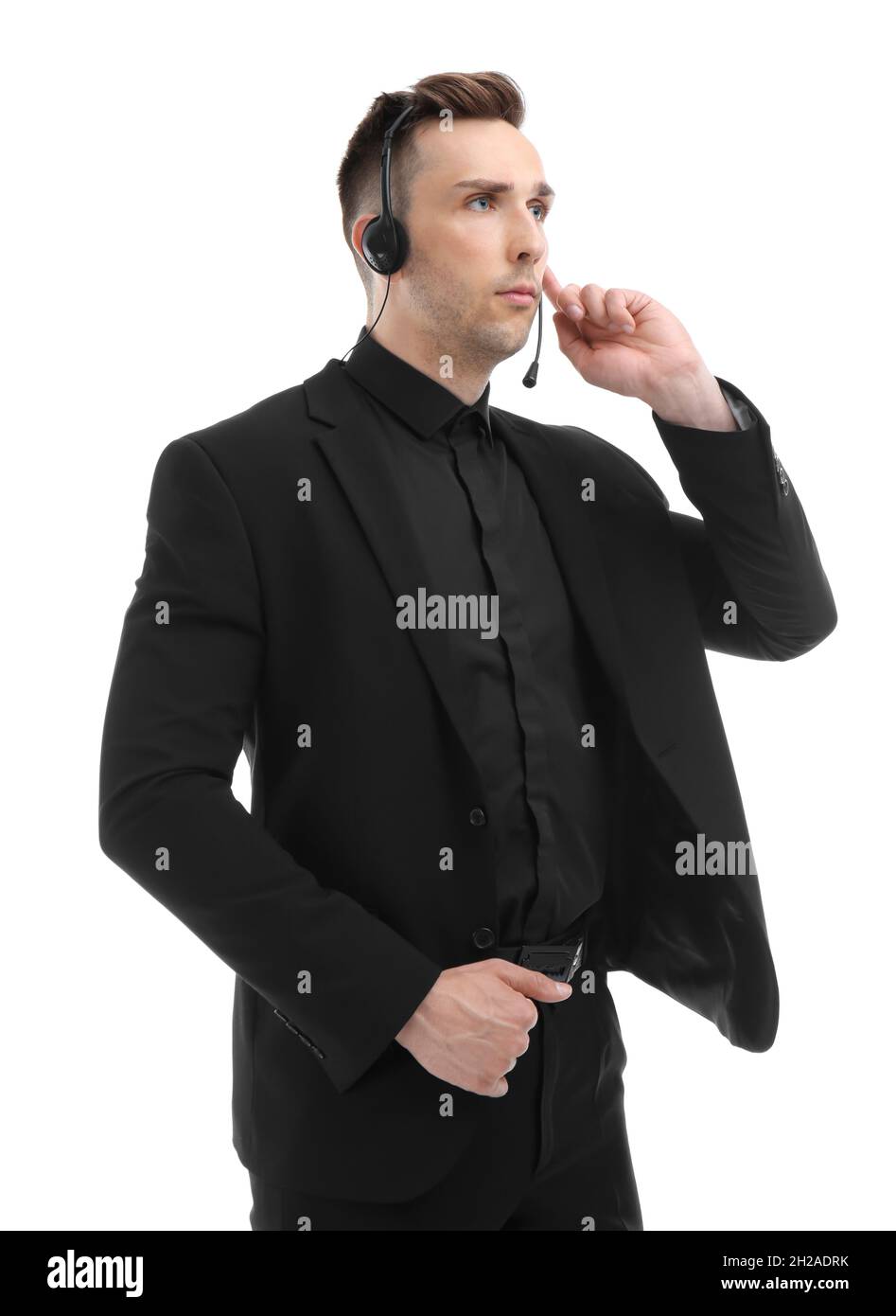 Male security guard with headset on white background Stock Photo - Alamy