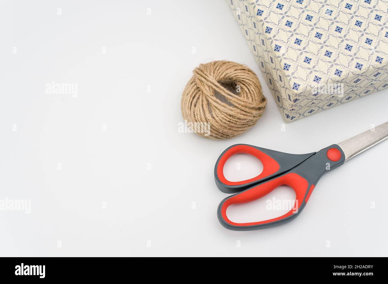 decorated paperboard box with scissors and decorative yarn on a white ...