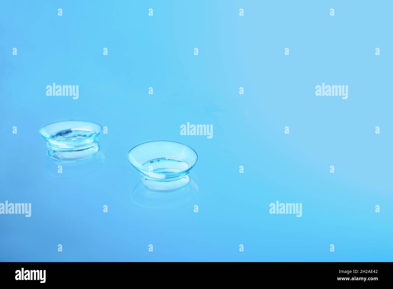 Contact lenses on glass background Stock Photo - Alamy