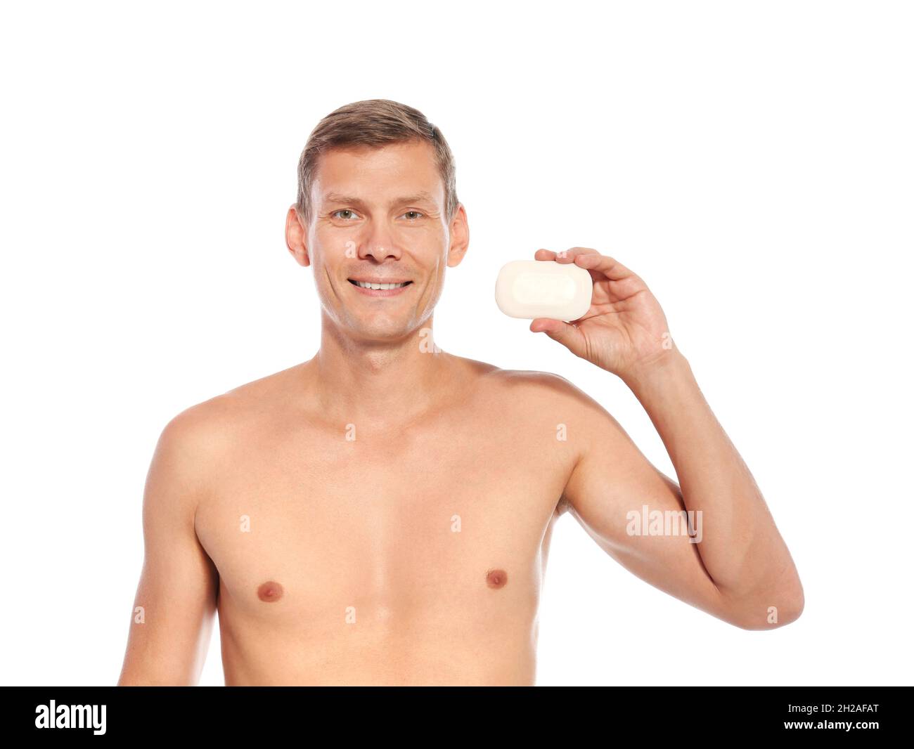 Portrait of man holding soap bar on white background Stock Photo - Alamy