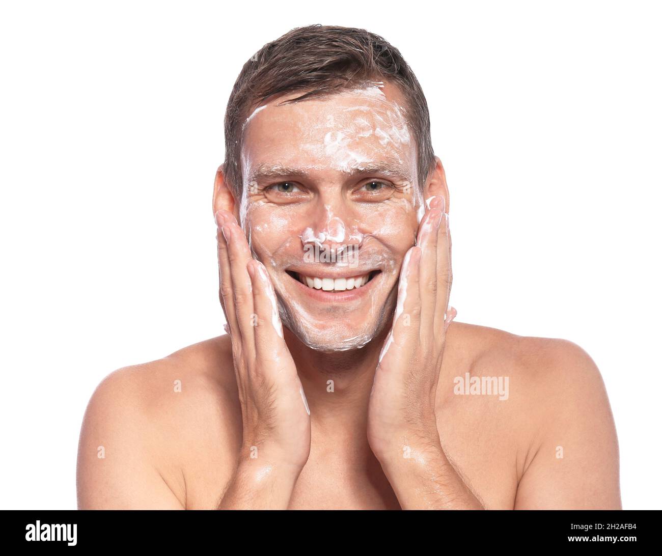 Man washing face with soap on white background Stock Photo - Alamy