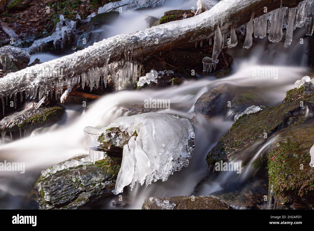 sculptures of Ice hanging on branches and rocks over a waterfall Stock ...