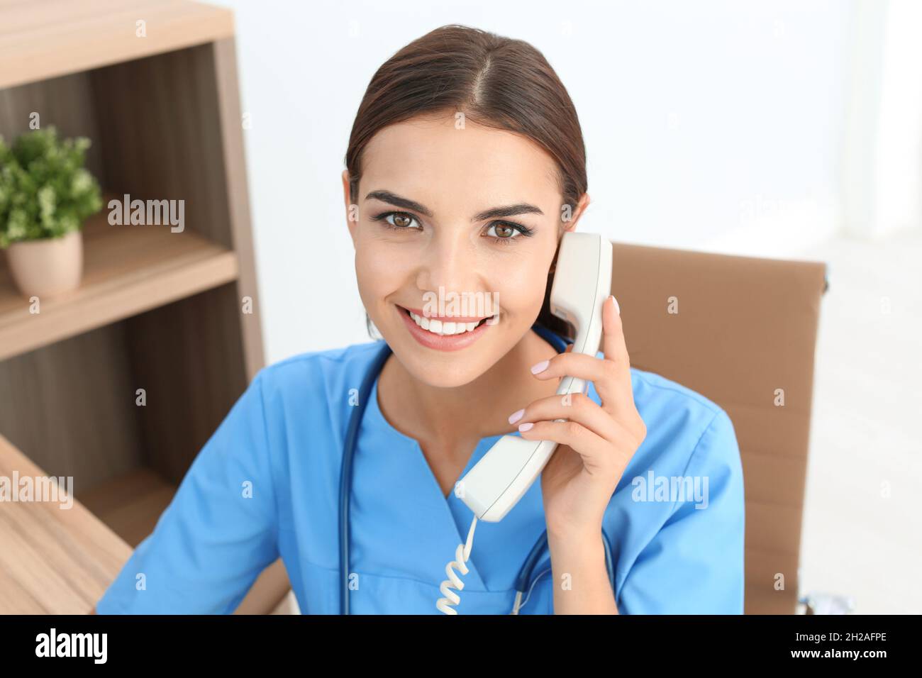Female medical assistant at workplace in clinic. Health care service ...