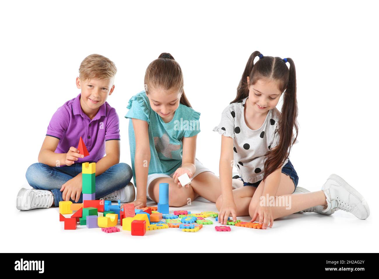 Little children playing together on white background. Indoor ...