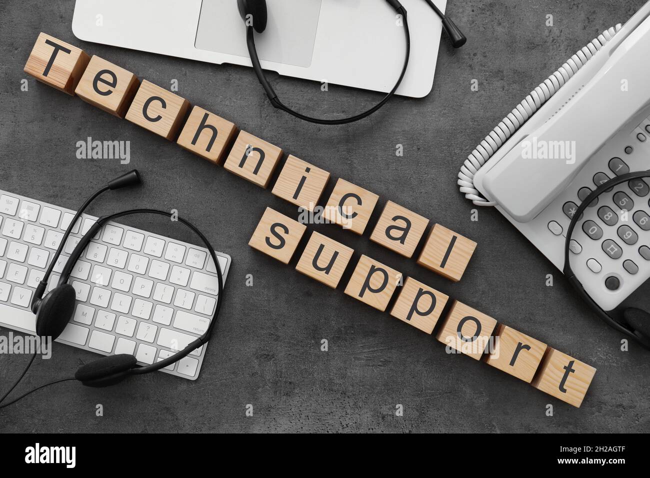 Flat lay composition with words TECHNICAL SUPPORT, phone and computer ...