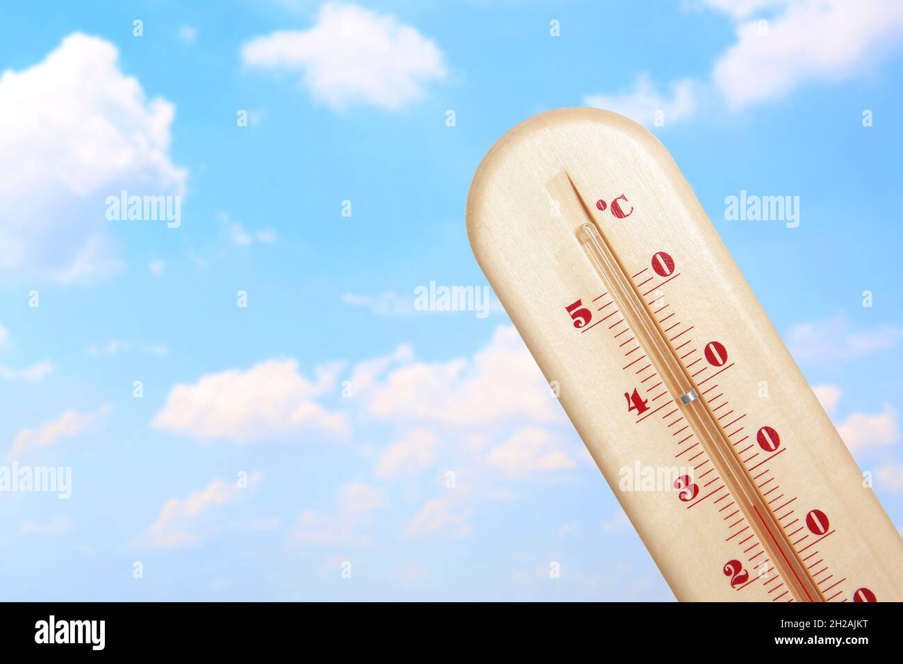 High temperature on thermometer and sky view Stock Photo - Alamy
