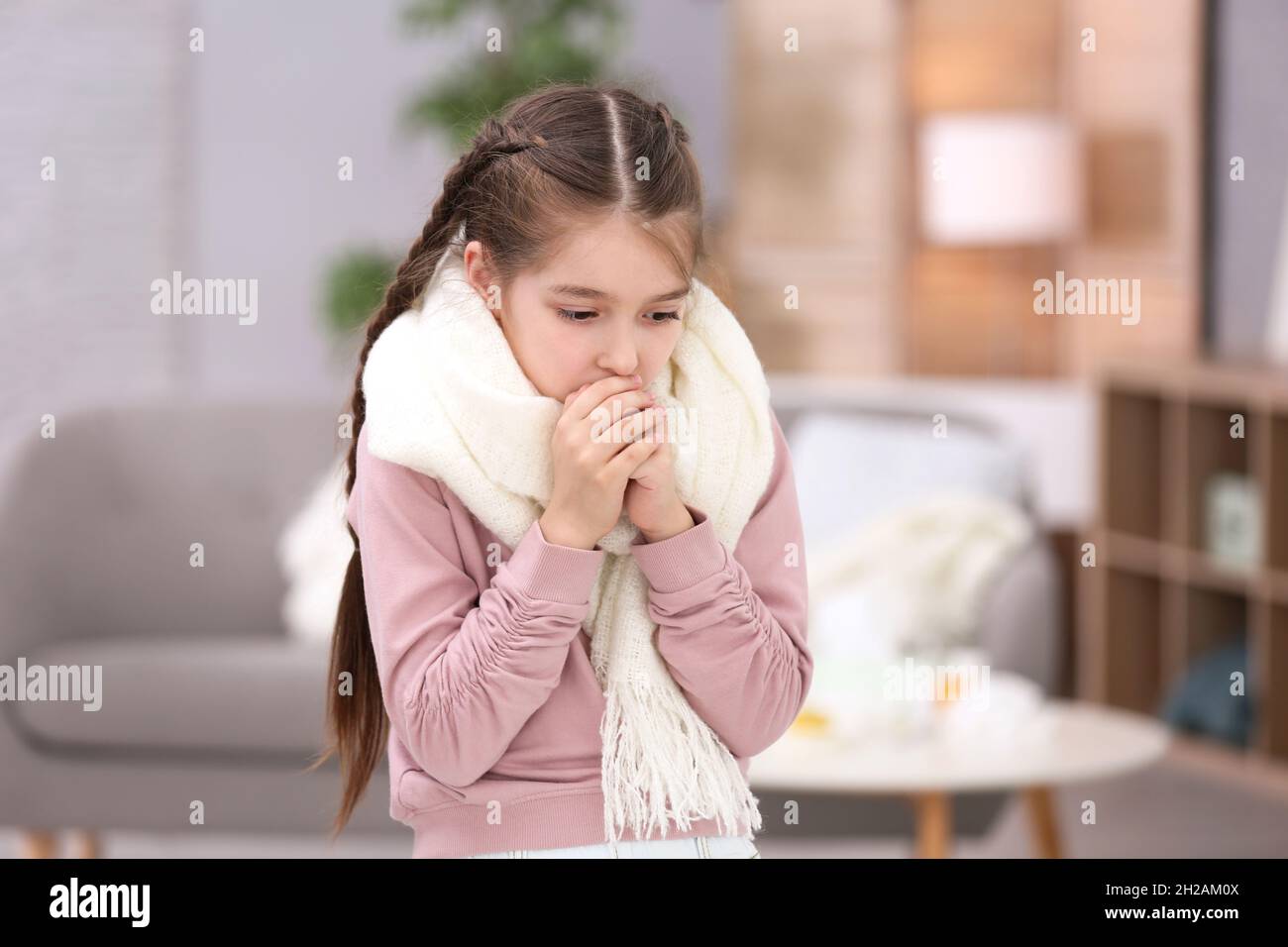 Sad little girl suffering from cold on blurred background Stock Photo ...